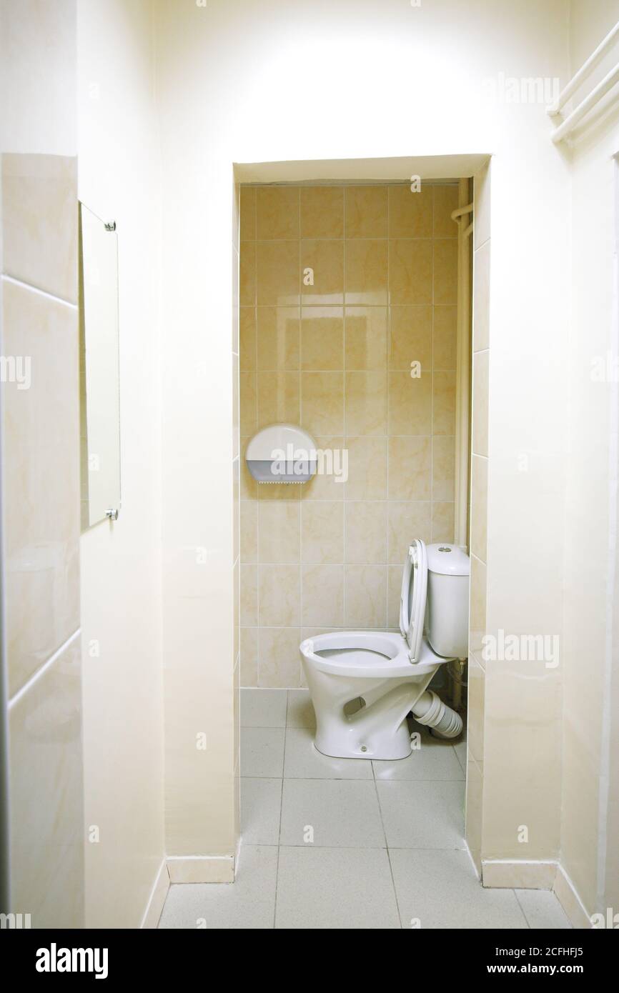 toilet inside one seat tan wall tiles Stock Photo - Alamy