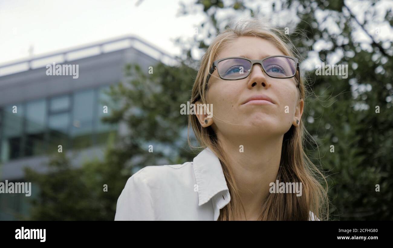 Beautiful young businesswoman outdoors thinking looking around Stock ...