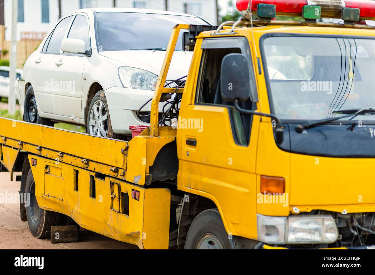 Broken car on car tow on the road Stock Photo - Alamy