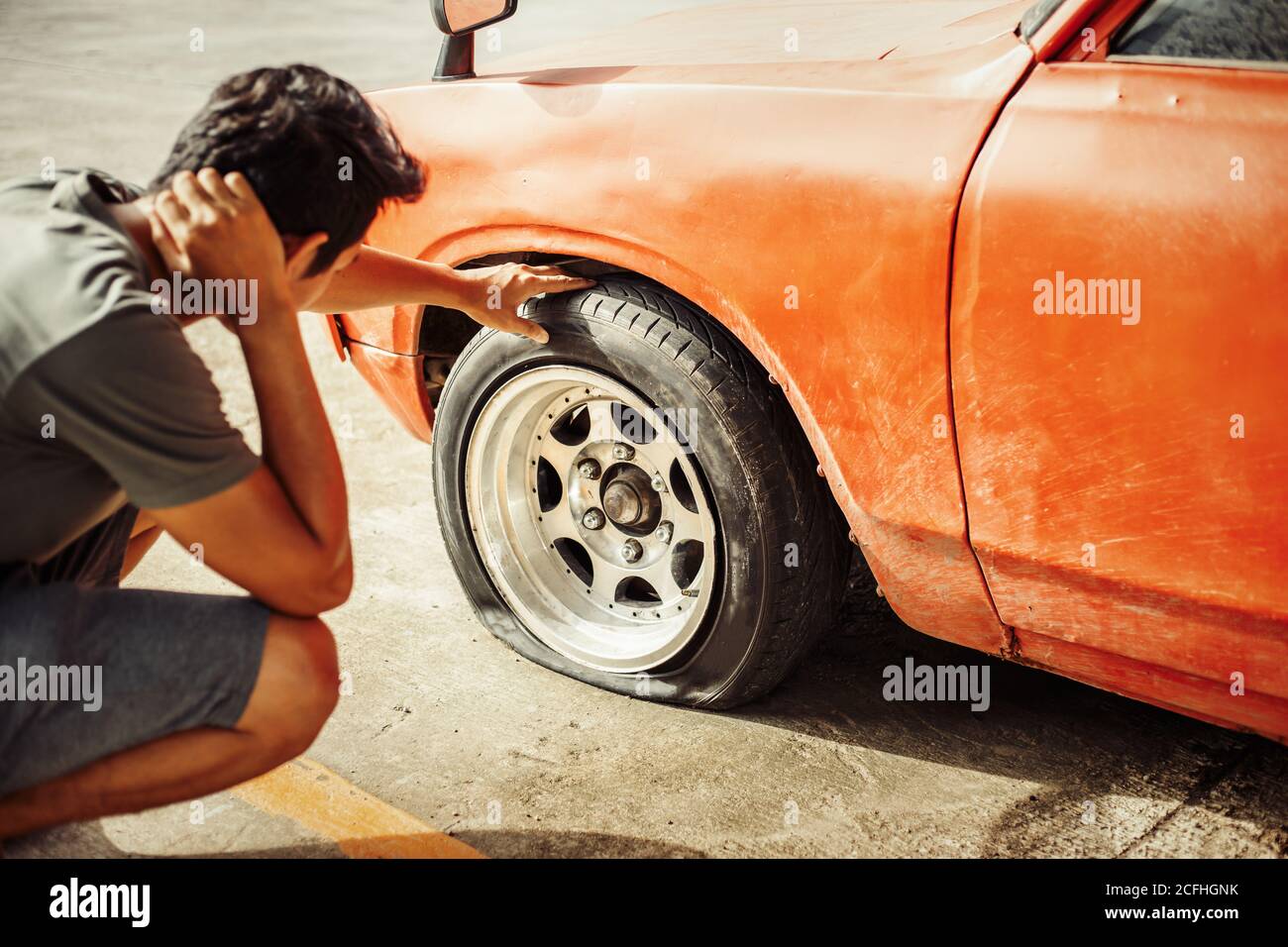 Man fixing a flat tire hi-res stock photography and images - Alamy