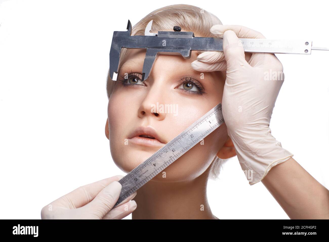 beauty blonde woman with measuring devices near face isolated on white ...