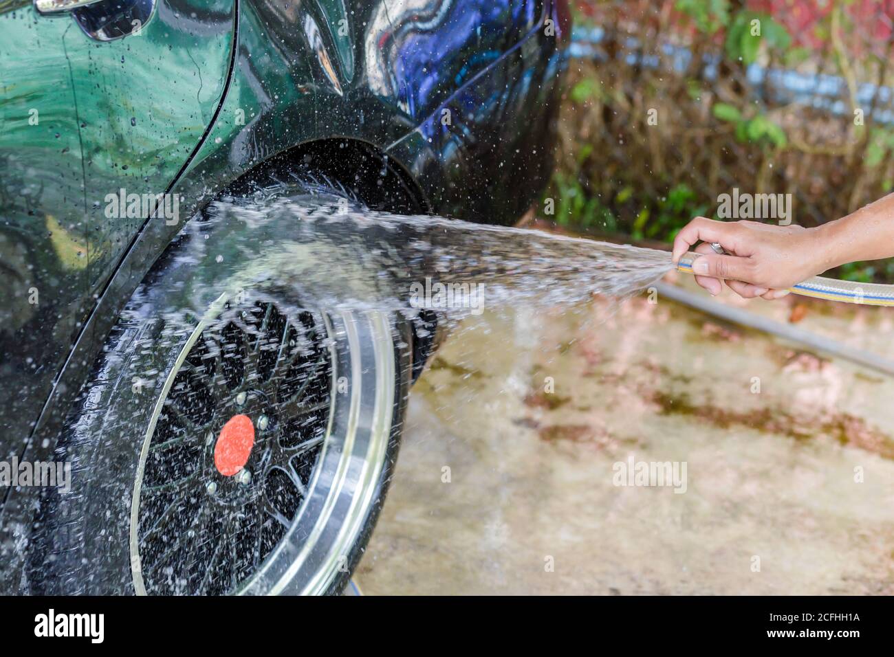 male hand with foam fabric washing car wheel Cleaning Wheels Use Water ...