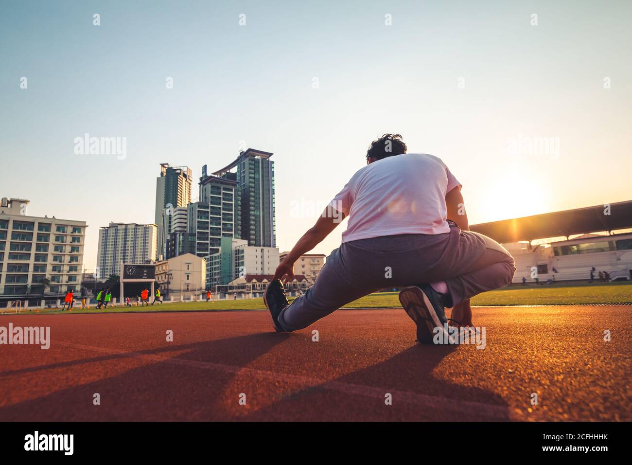 Full length portrait of a athletic man stretching in the morning and ...