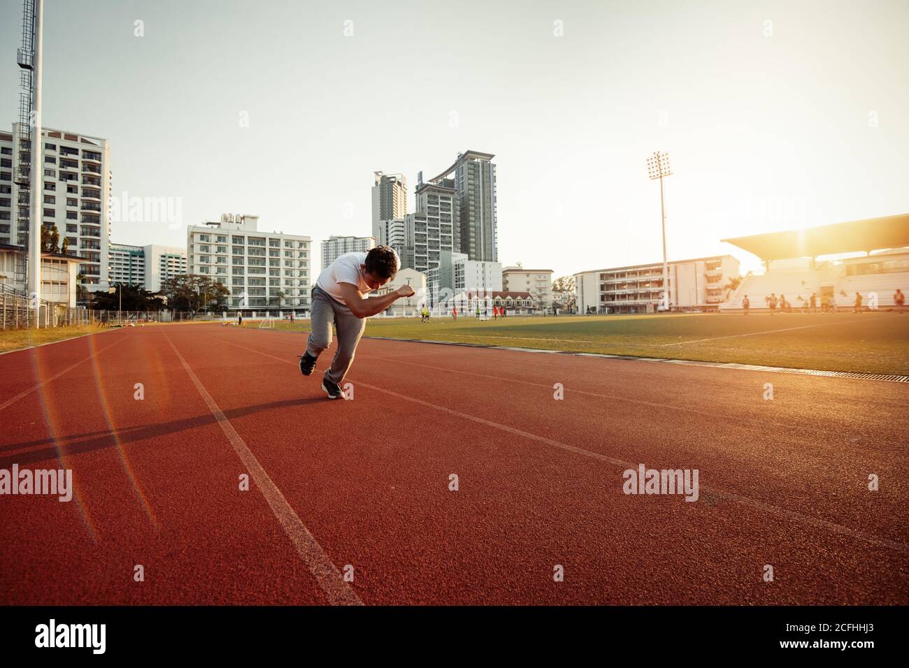 A man start running on track race at sport stadium Stock Photo - Alamy