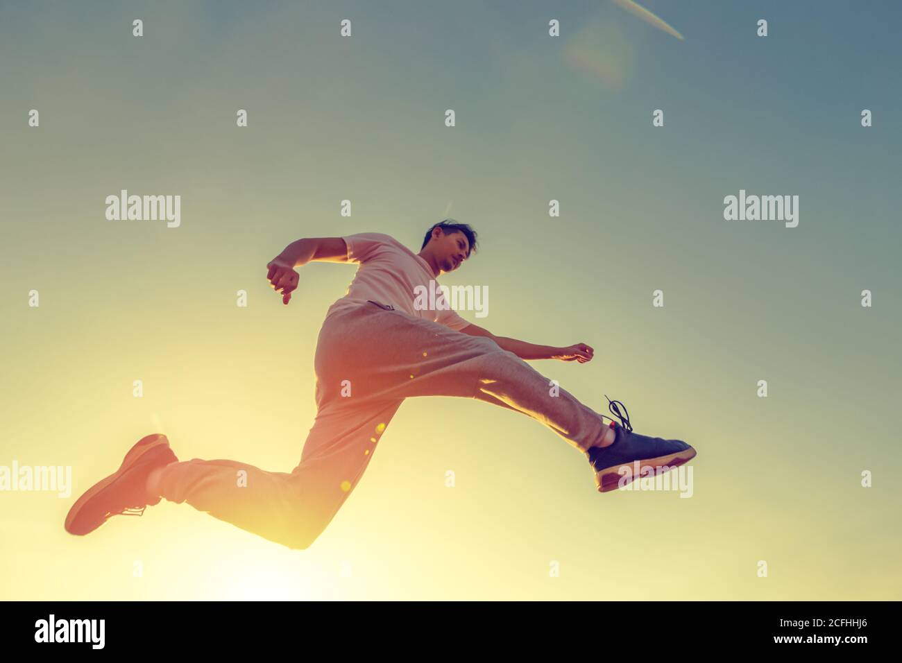 Happy young man running upstairs hi-res stock photography and images ...