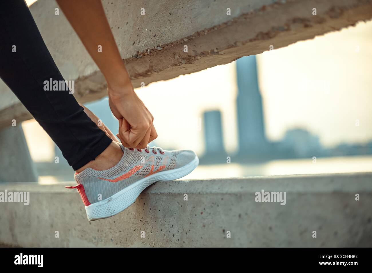 Woman tying shoe laces Stock Photo - Alamy