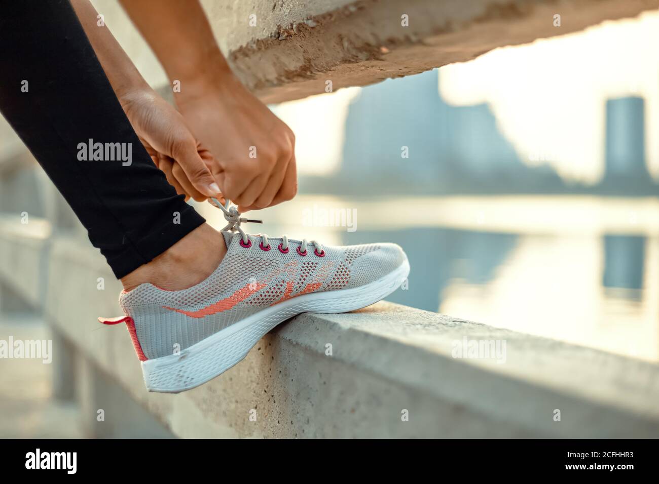 Woman tying shoe laces Stock Photo - Alamy