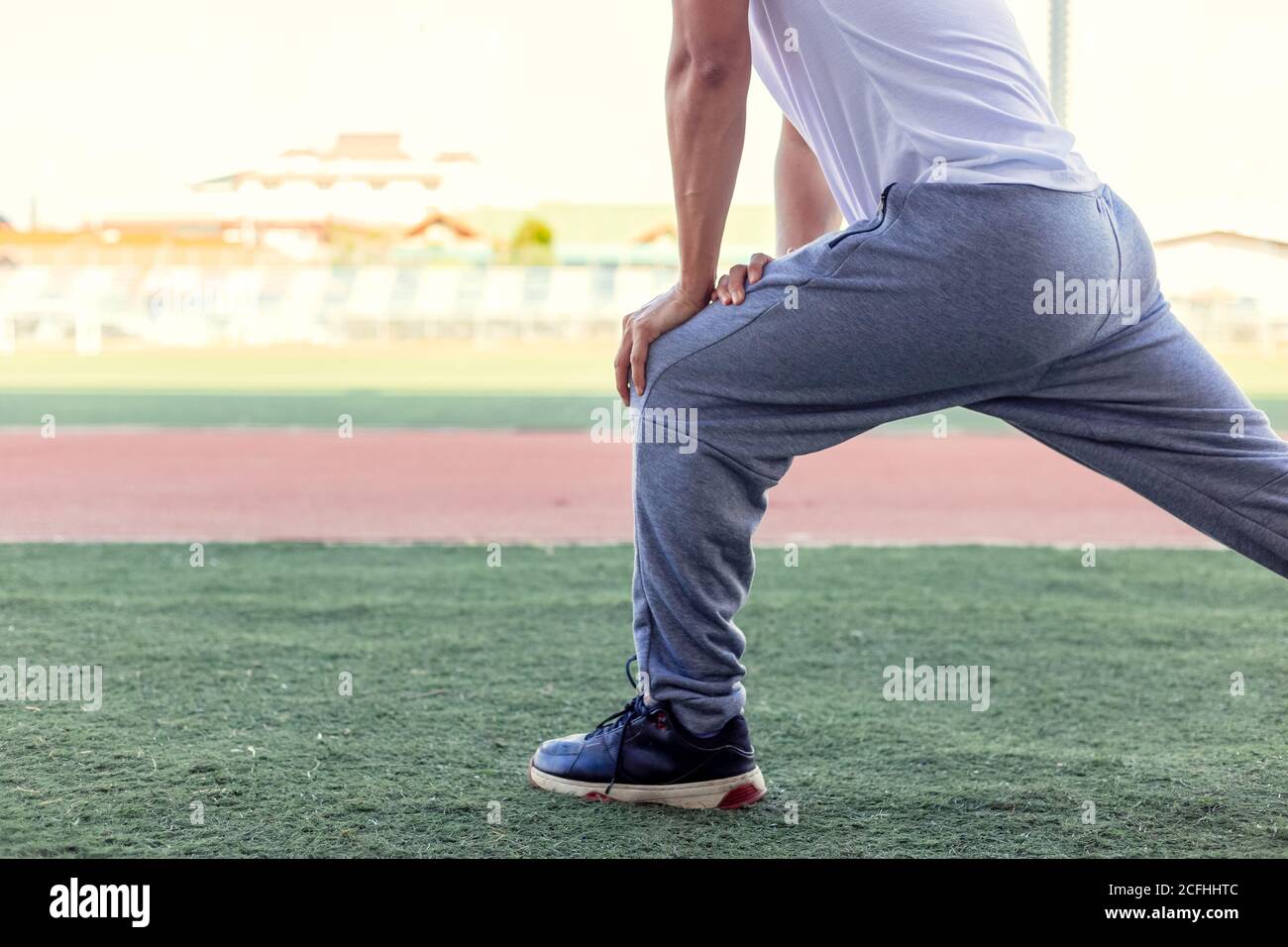 Full length portrait of a athletic man stretching in the morning and ...