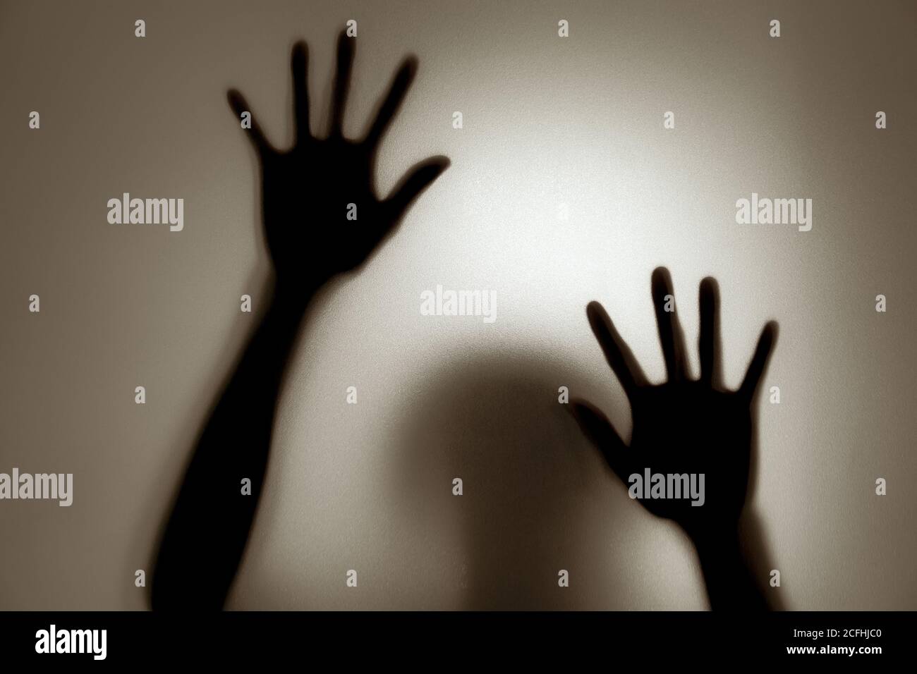 Ghost concept shadow of a woman behind the matte glass blurry hand and ...