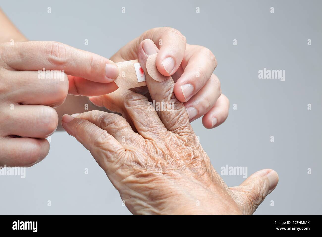 Woman putting on plaster hi-res stock photography and images - Alamy
