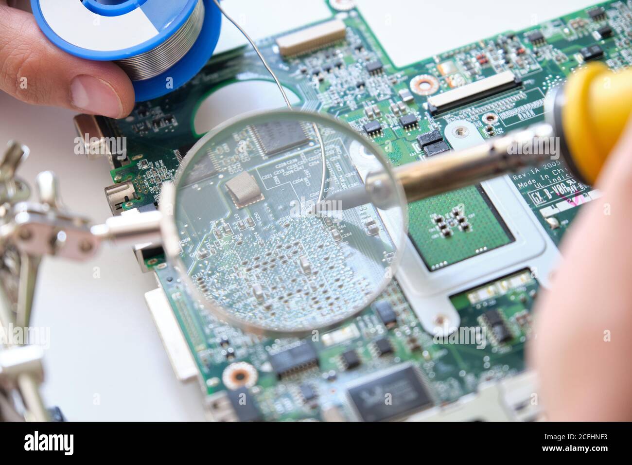 Repairing a printed circuit board with a soldering iron through a ...