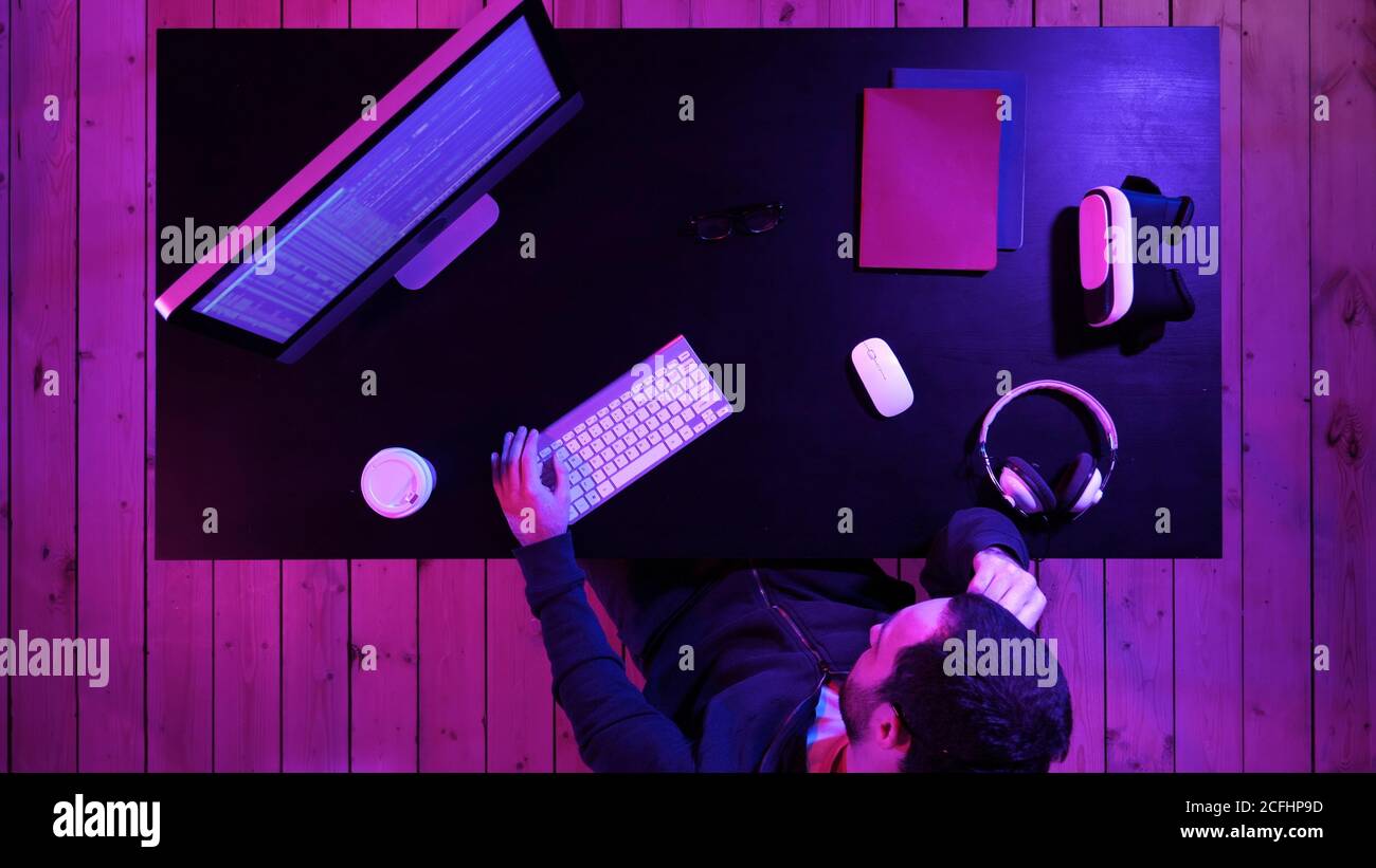 Tired hacker sleeping near computer while computer processing Stock ...