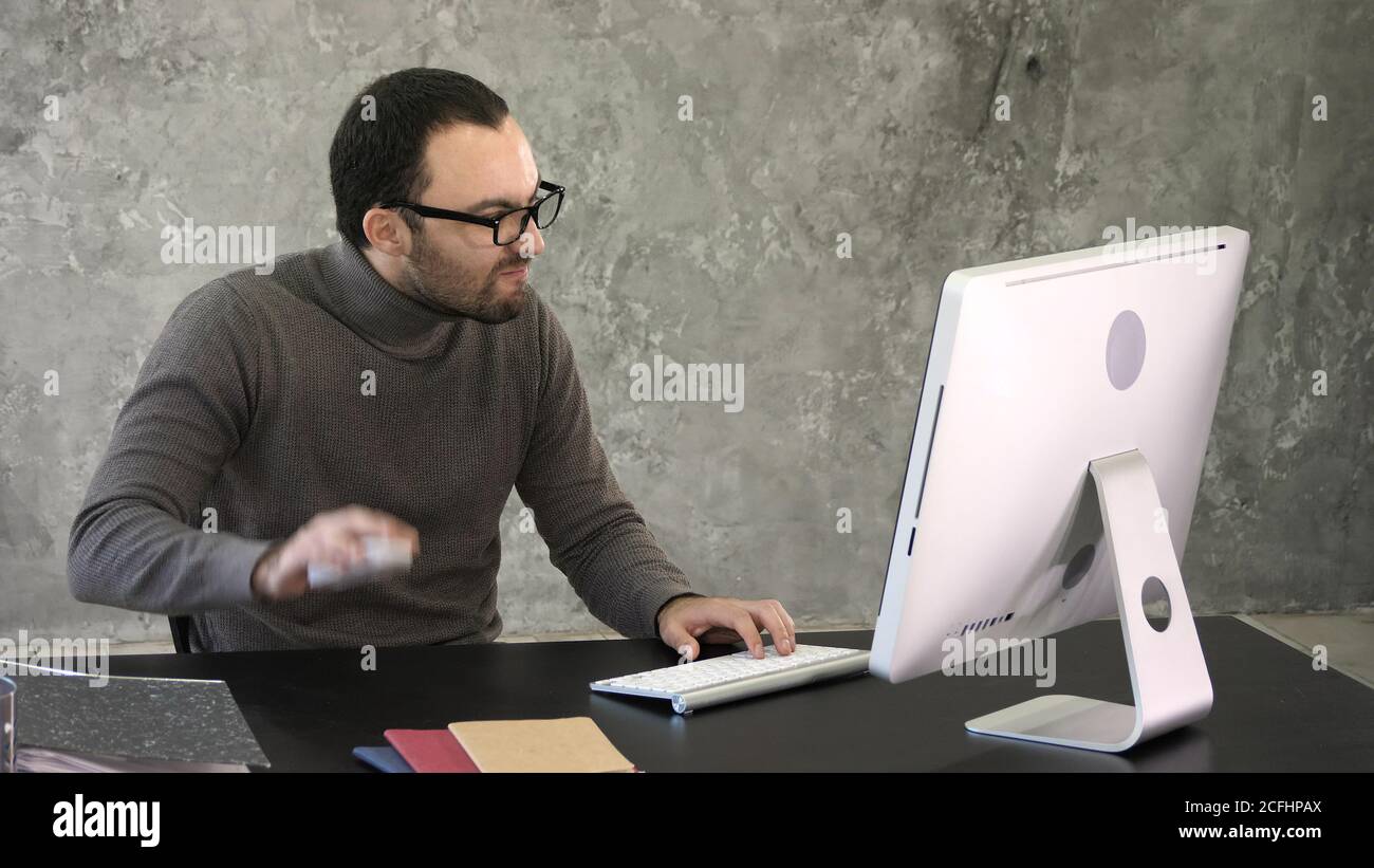 Entrepreneur angry and furious at computer. Reaction to something on ...