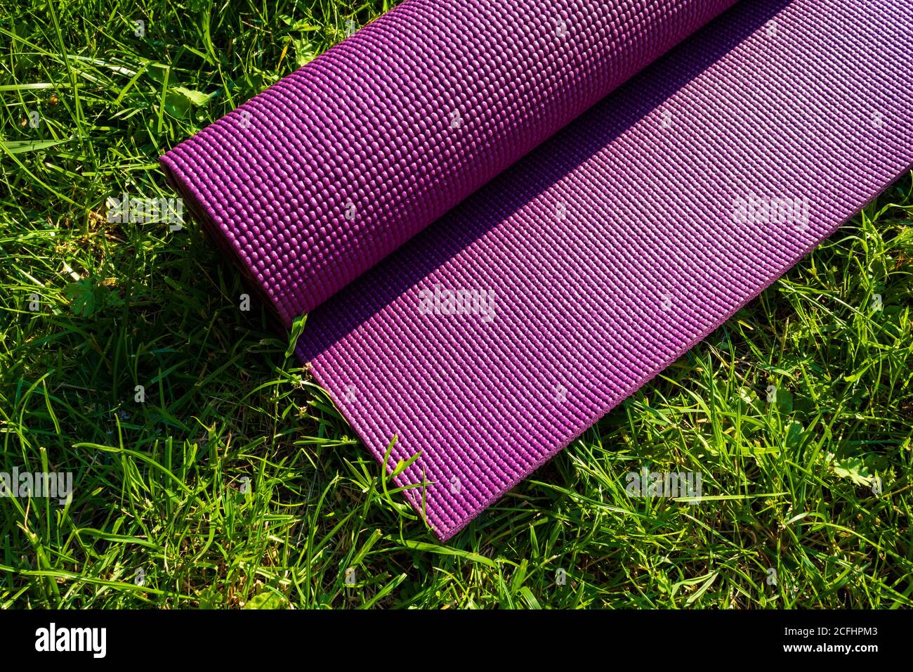 Closeup shot of a fitness mat on grass Stock Photo - Alamy