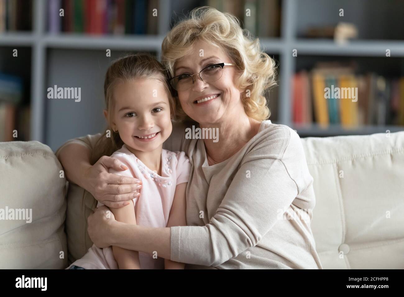 Head shot portrait smiling mature grandmother and pretty granddaughter ...