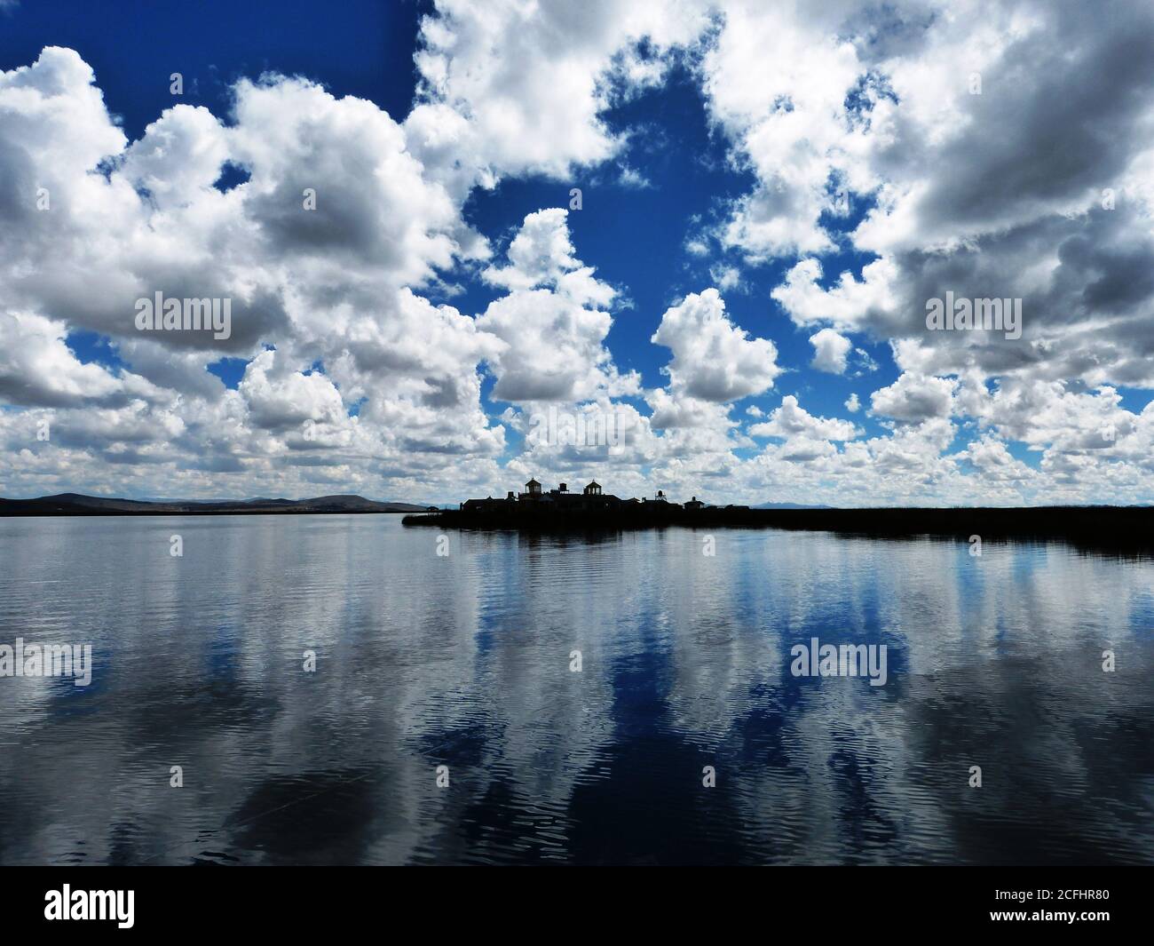 Cloudscape over famous beautiful Titicaca Lake in Peru.Floating island ...