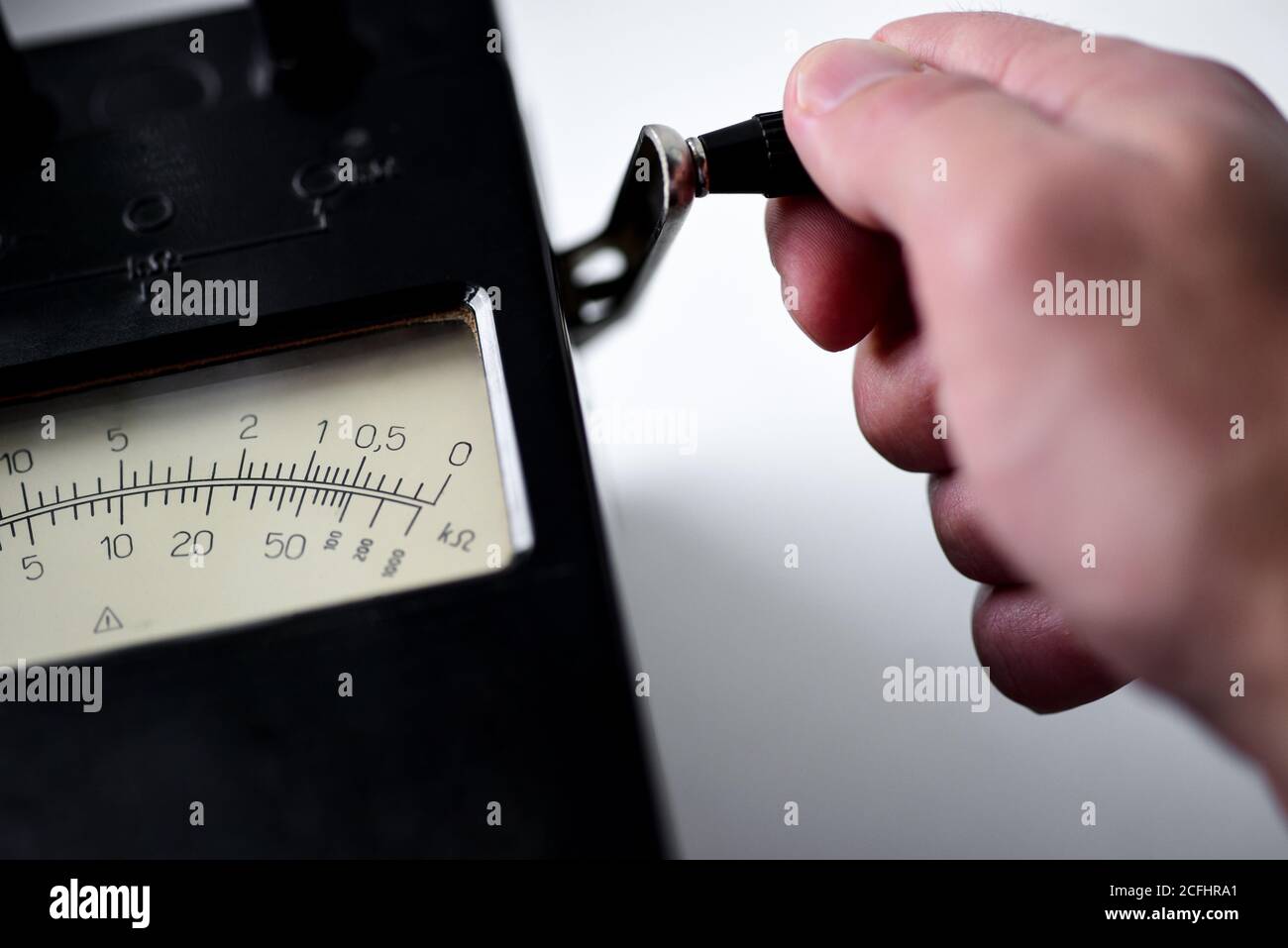 Cable insulation resistance tester, hand turns the handle Stock Photo ...