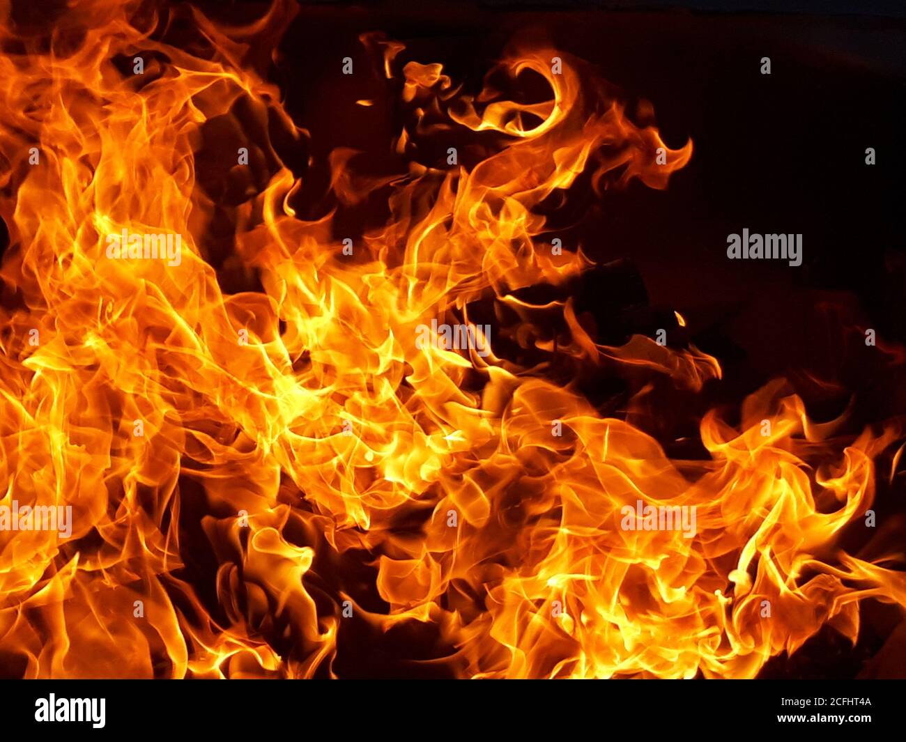 Closeup of fire flames at night with a blurry background - great for ...