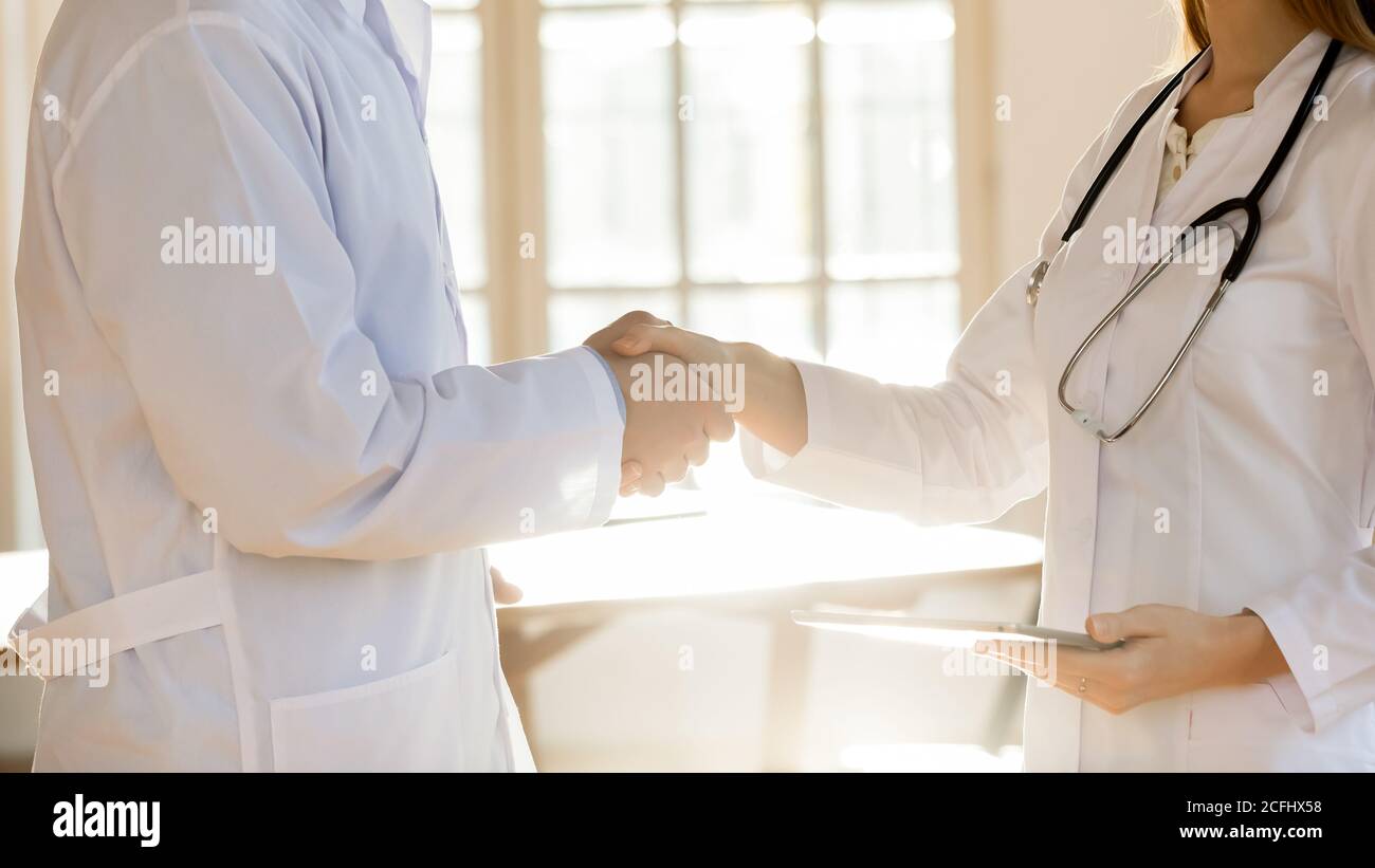 Two young doctors handshake hi-res stock photography and images - Alamy