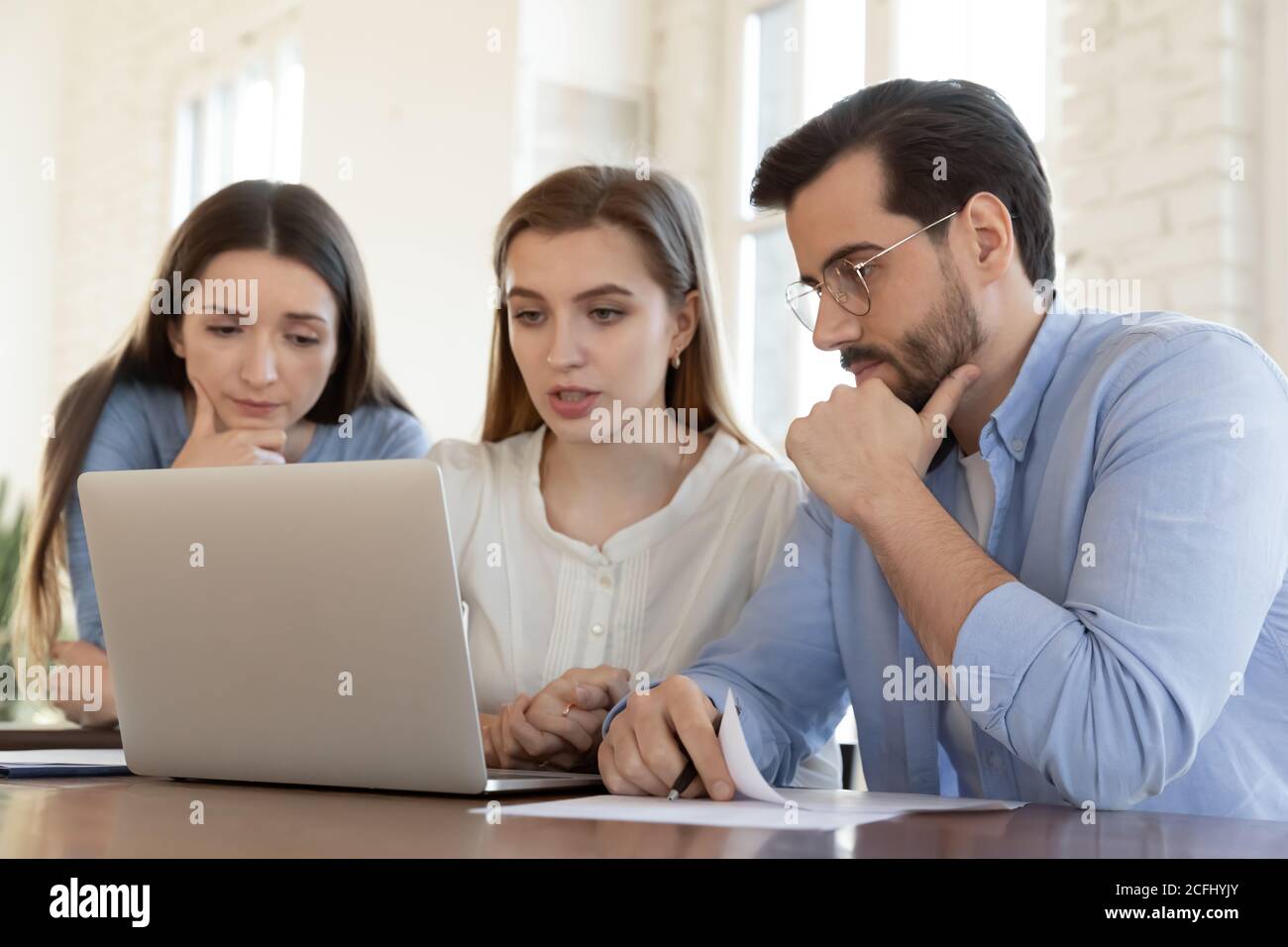 Colleagues working on project together, solving problem, discussing ...