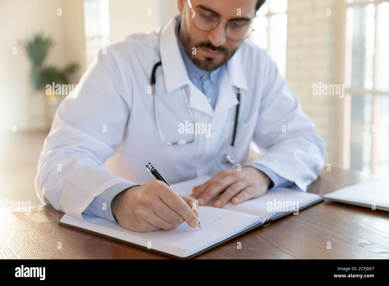 Close up focused doctor wearing uniform working with documents Stock ...