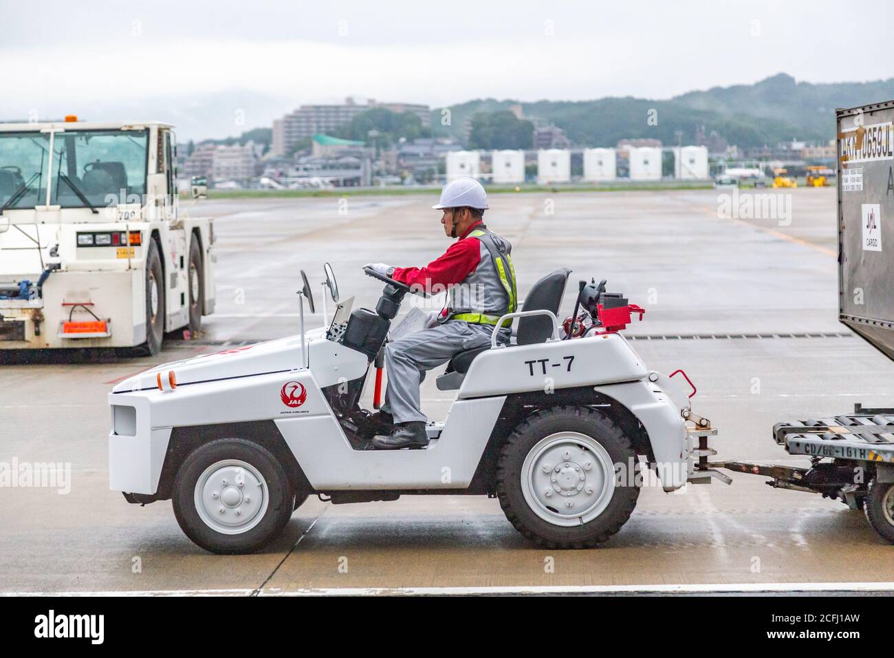 Fukuoka, Japan - 14 July 2019 - Airport baggage handler drives a ...