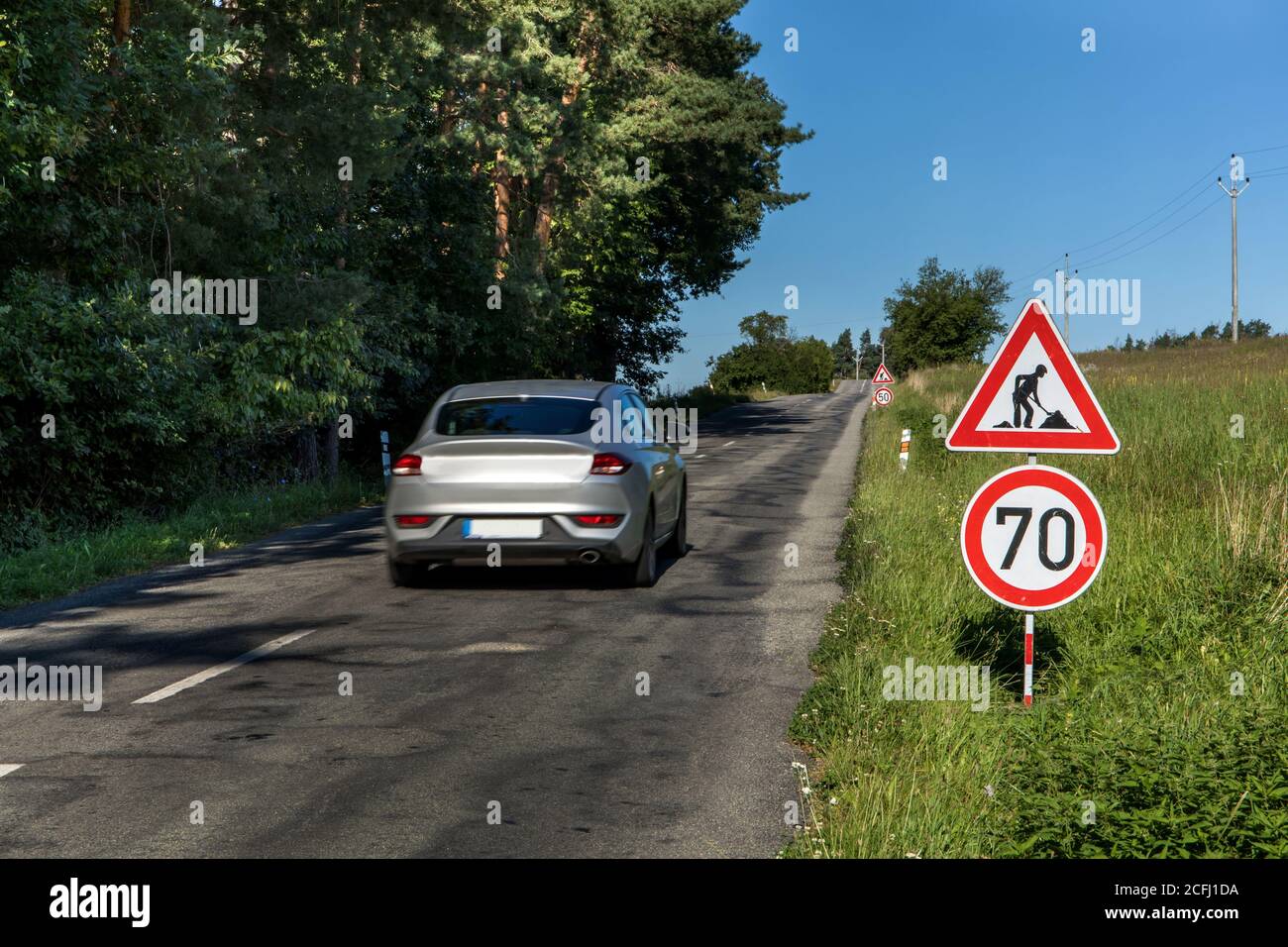Roadworks signs on a Country Road and Blue Sky. Summer morning on a ...