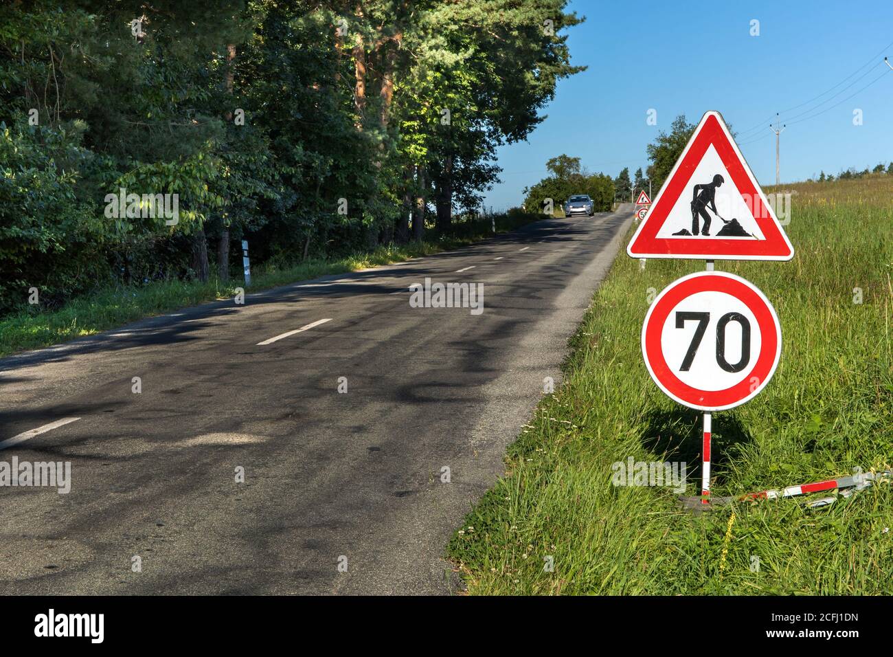 Roadworks signs on a Country Road and Blue Sky. Summer morning on a ...