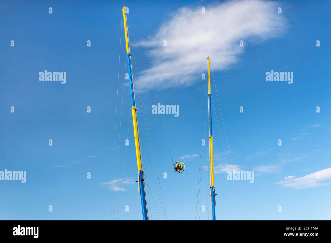 Launching a catapult in an amusement park with two people sitting in a ...