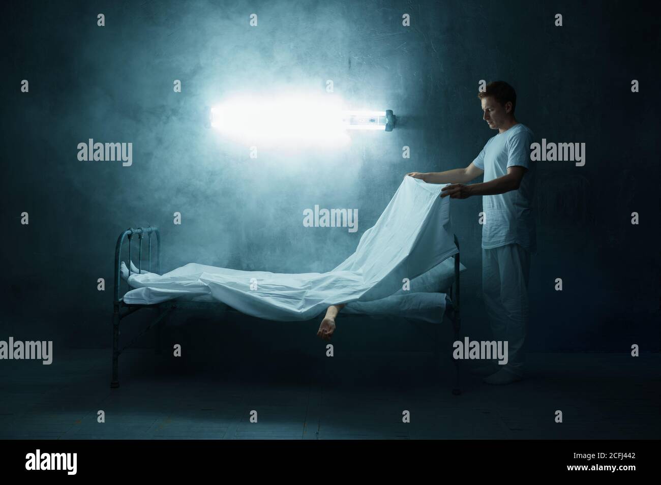 Sad psycho man looking on woman in bed, hospital Stock Photo - Alamy