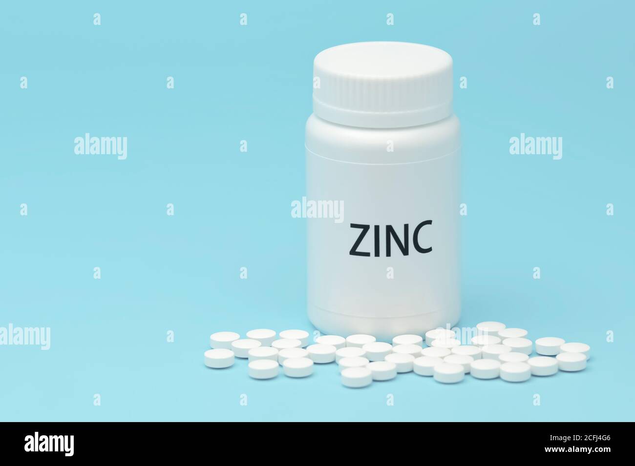 ZINC in white bottle packaging with scattered pills. Nutritional ...