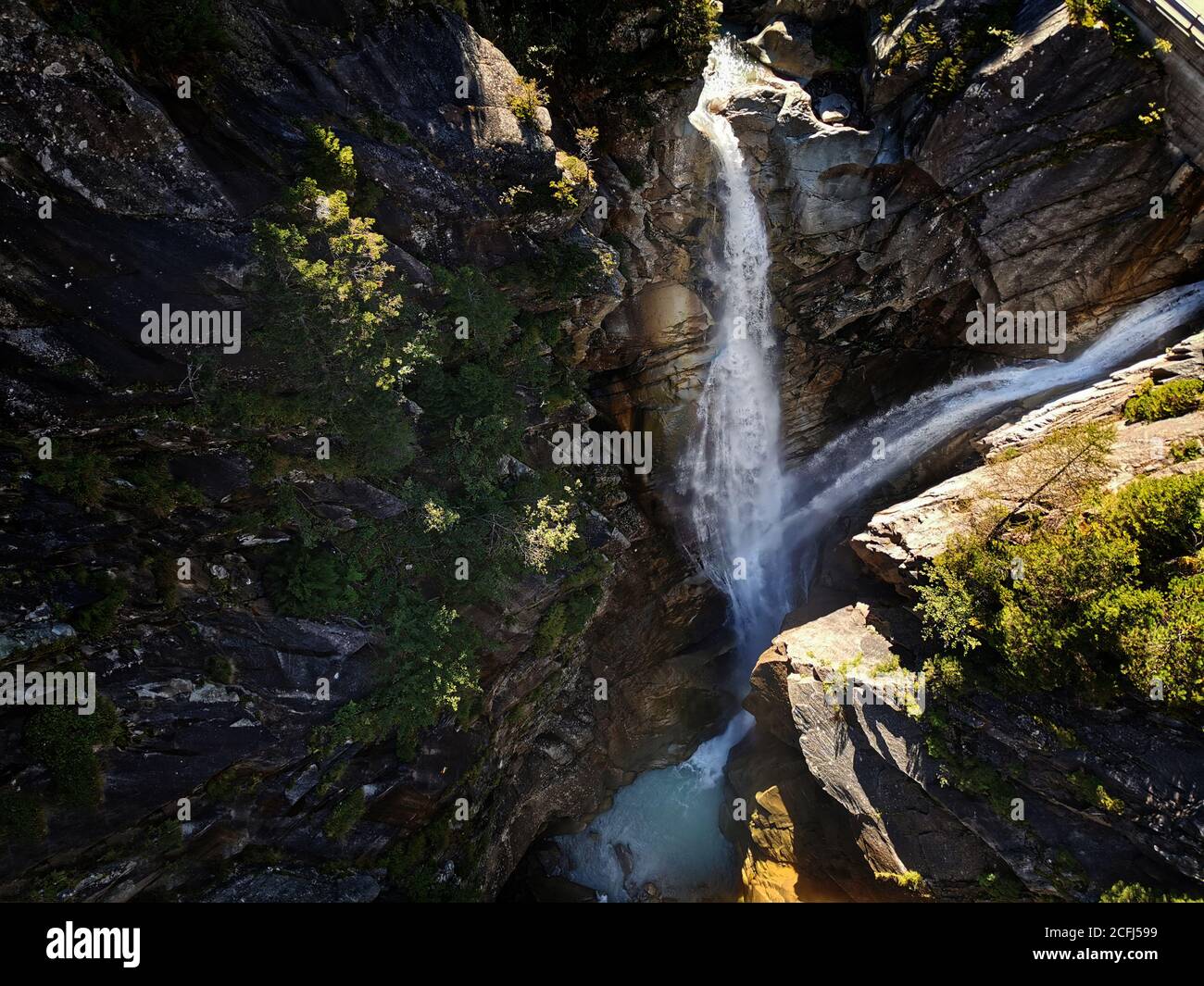 water fall shot from above. Stream running over rocky cliff in ...