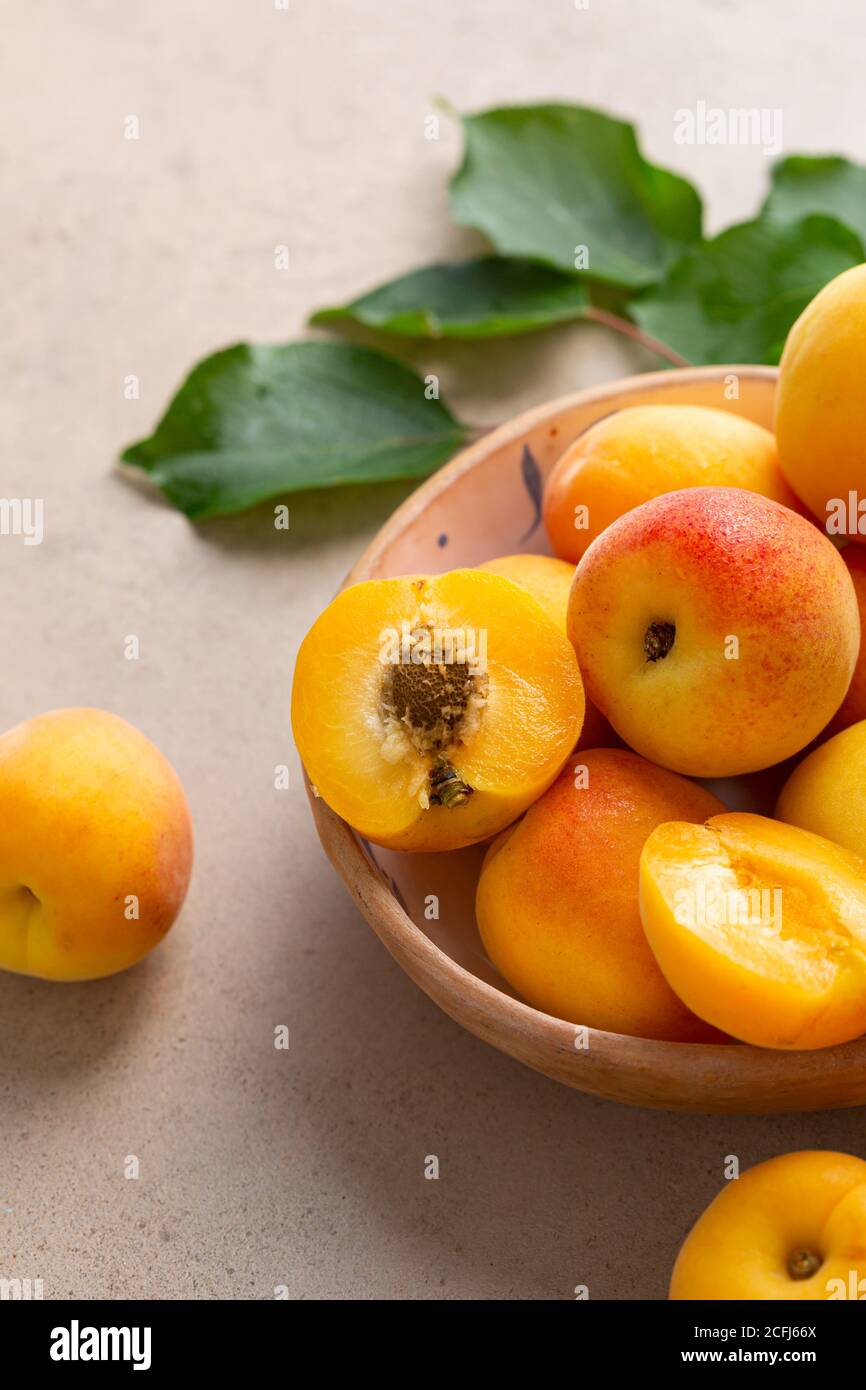 Close up of Raw ripe apricots in bowl on stone table Stock Photo - Alamy