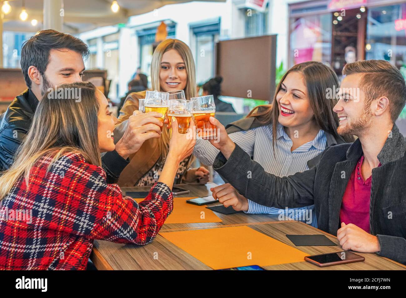 Young happy friends drinking beer - Friendship and celebration concept ...