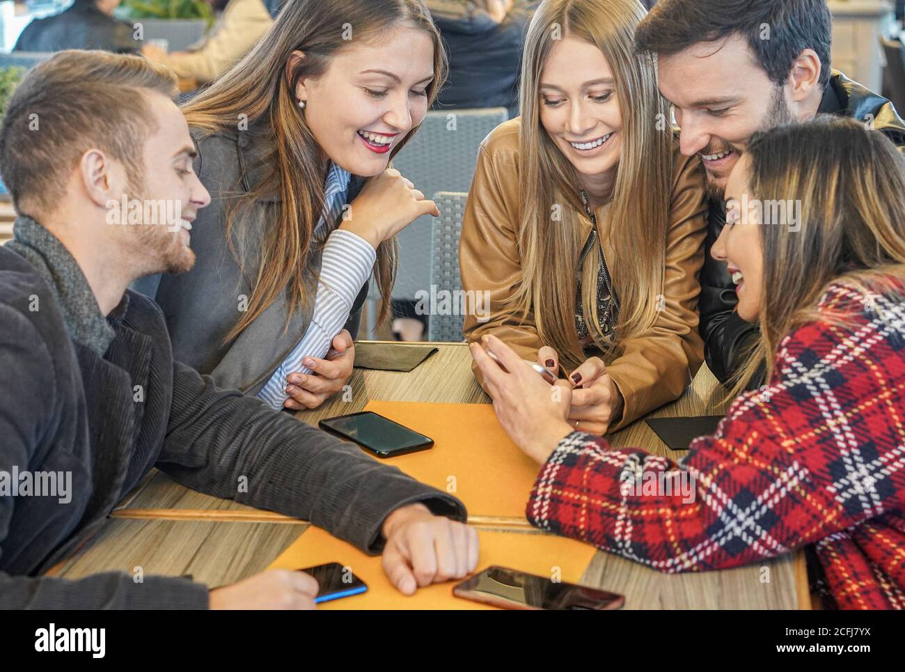 Group of friends watching mobile phones and having fun Stock Photo - Alamy