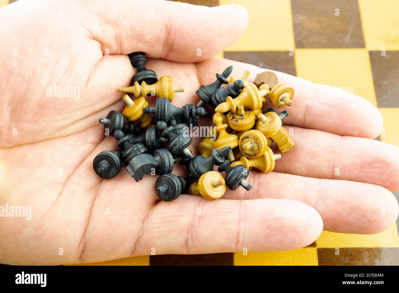 small wooden chess pieces in the hand of the chess player Stock Photo ...