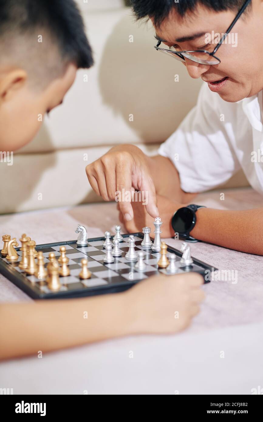 Father and son playing chess Stock Photo - Alamy