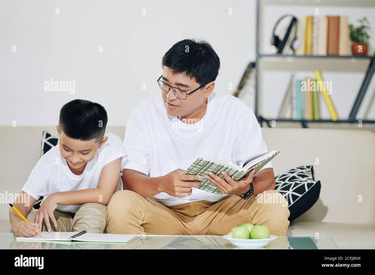 Doing homework with father Stock Photo - Alamy