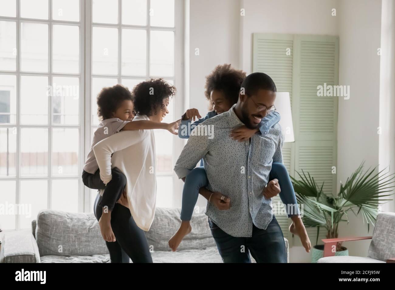Happy african american family playing catch up at home Stock Photo - Alamy
