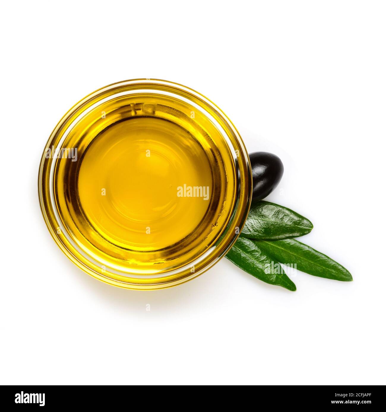 Olive oil. Extra virgin olive oil in glass transparent bowl with leaves ...