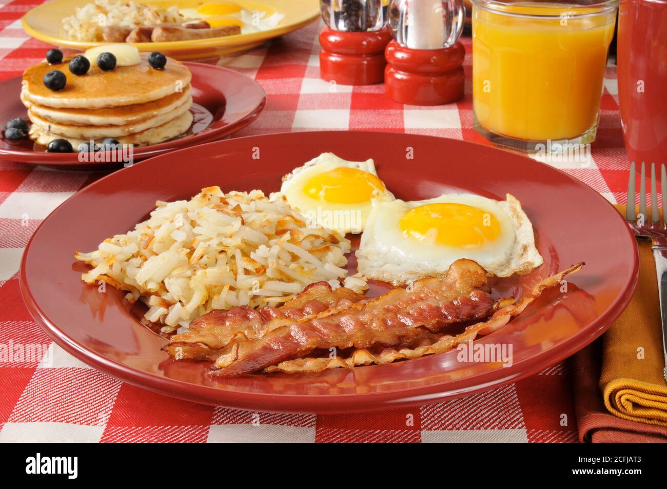 A bacon and egg breakfast with blueberry hotcakes Stock Photo - Alamy