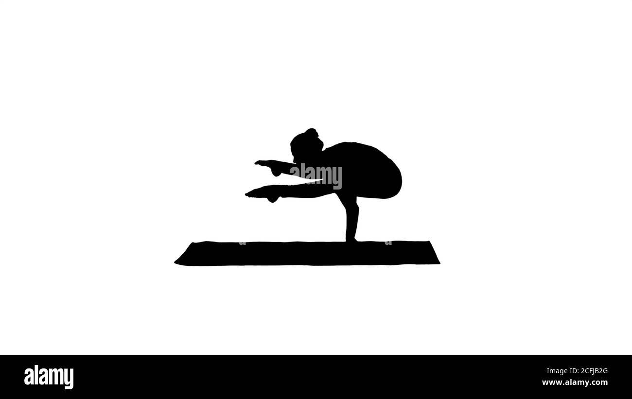 Silhouette Beautiful woman practices handstand yoga asana Tittibhasana ...
