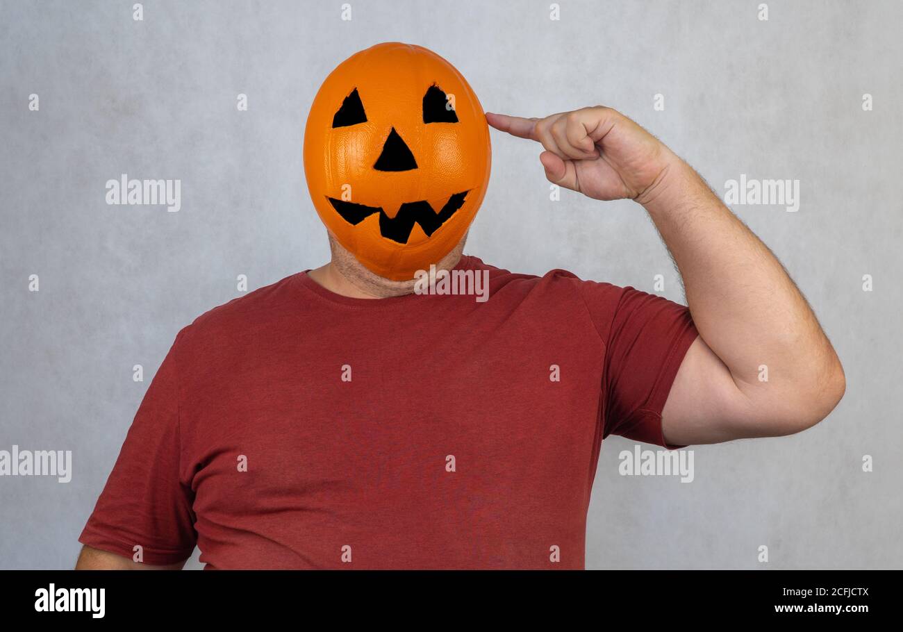 man in a Halloween mask on a white background. person with orange ...