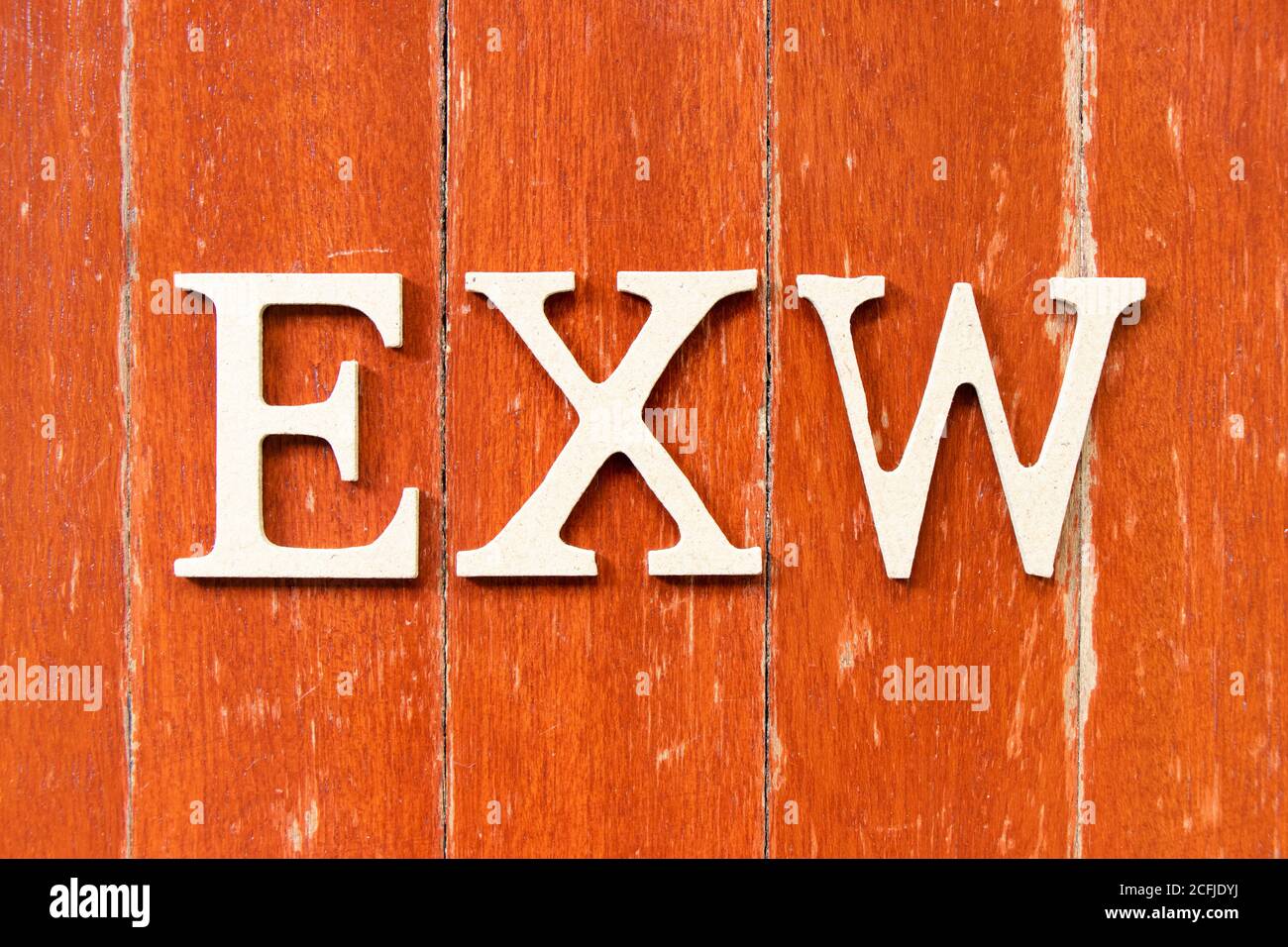Alphabet letter in word EXW (abbreviation of Ex works) on old red color ...