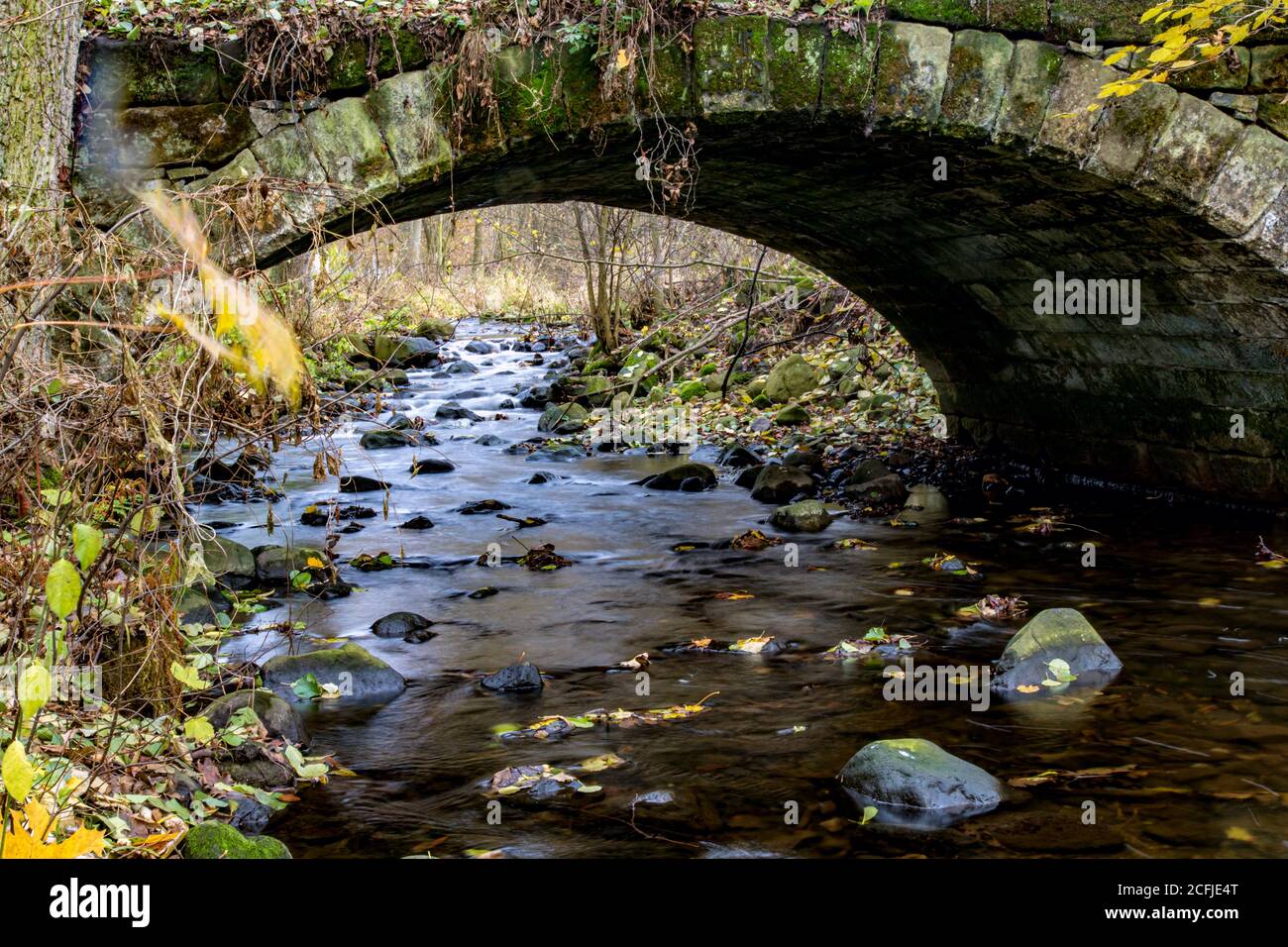 Stream flowing under stone bridge hi-res stock photography and images ...