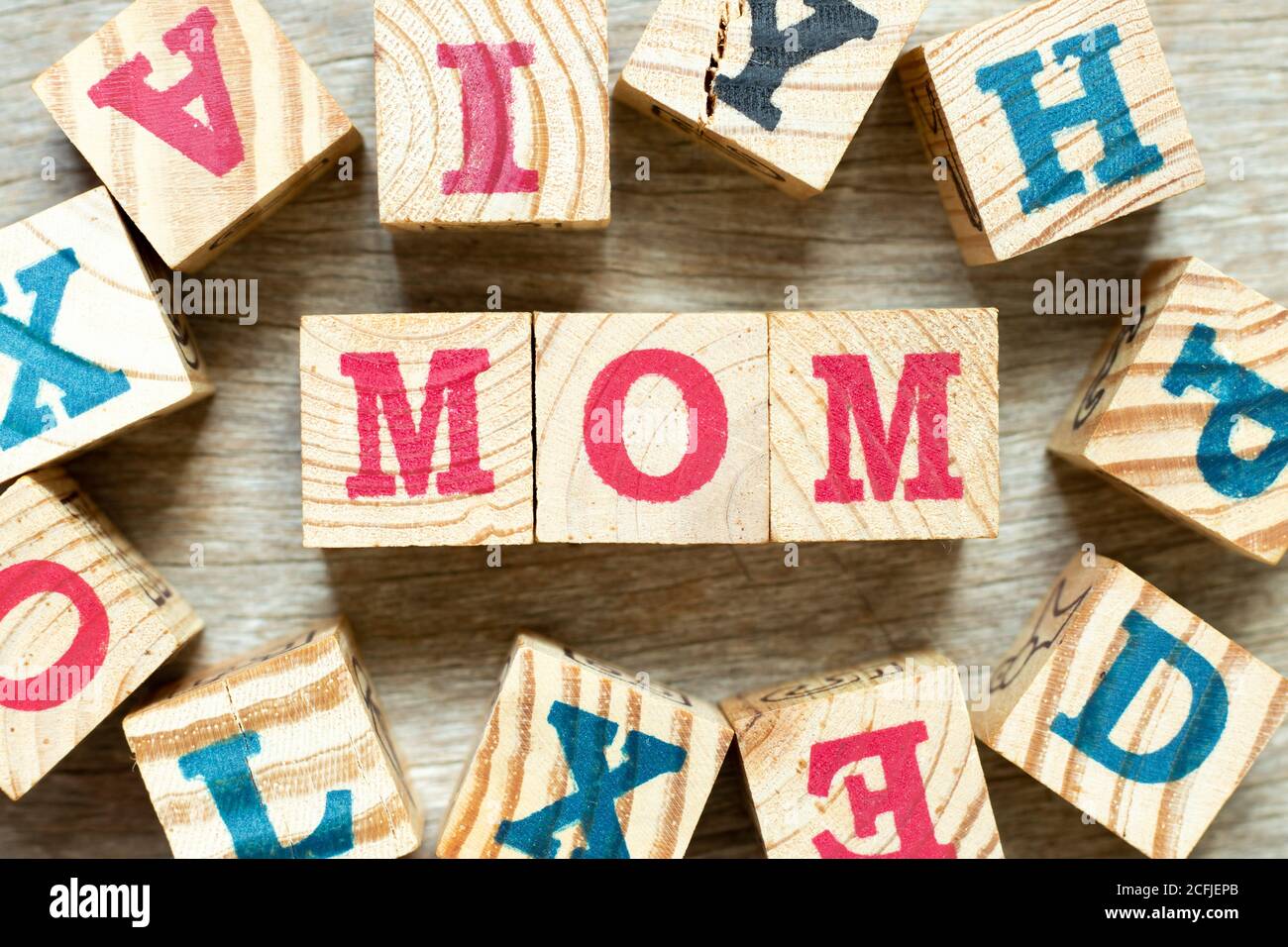 Alphabet letter block in word mom with another on wood background Stock ...