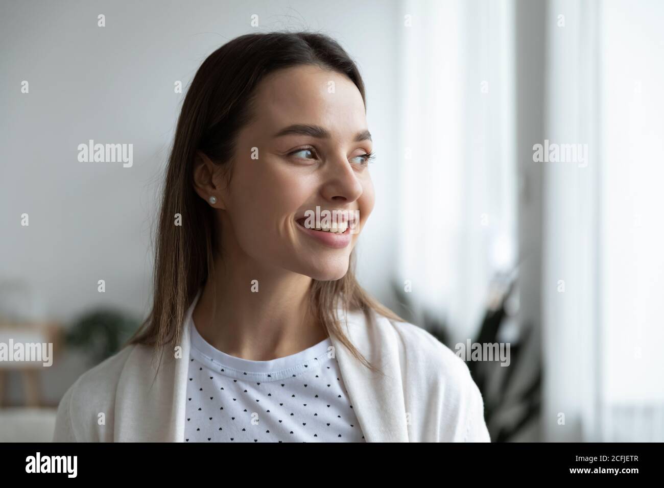 Dreamy young smiling beautiful woman visualizing future Stock Photo - Alamy
