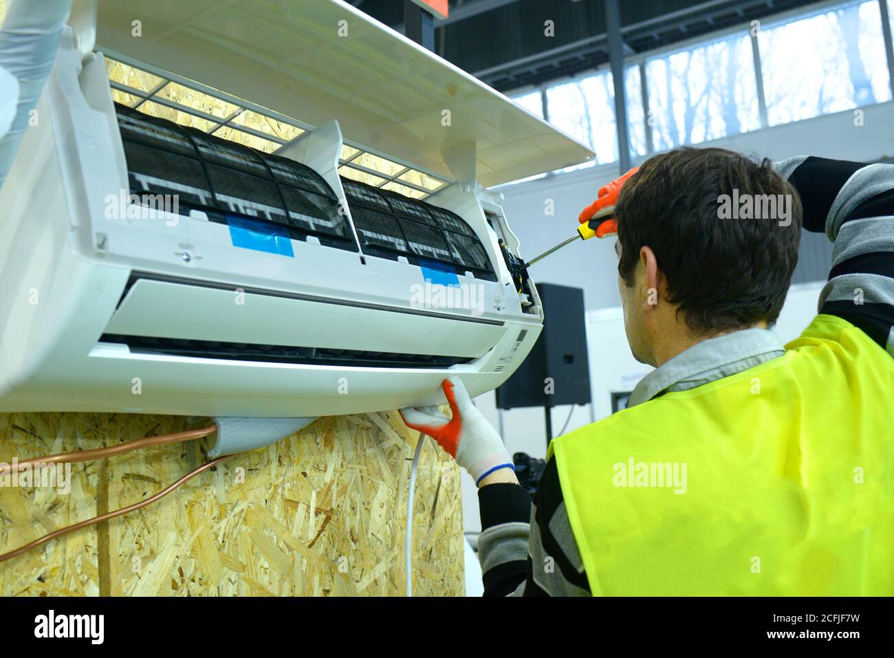 Male fitter assembling an air conditioner using screwdriver Stock Photo ...