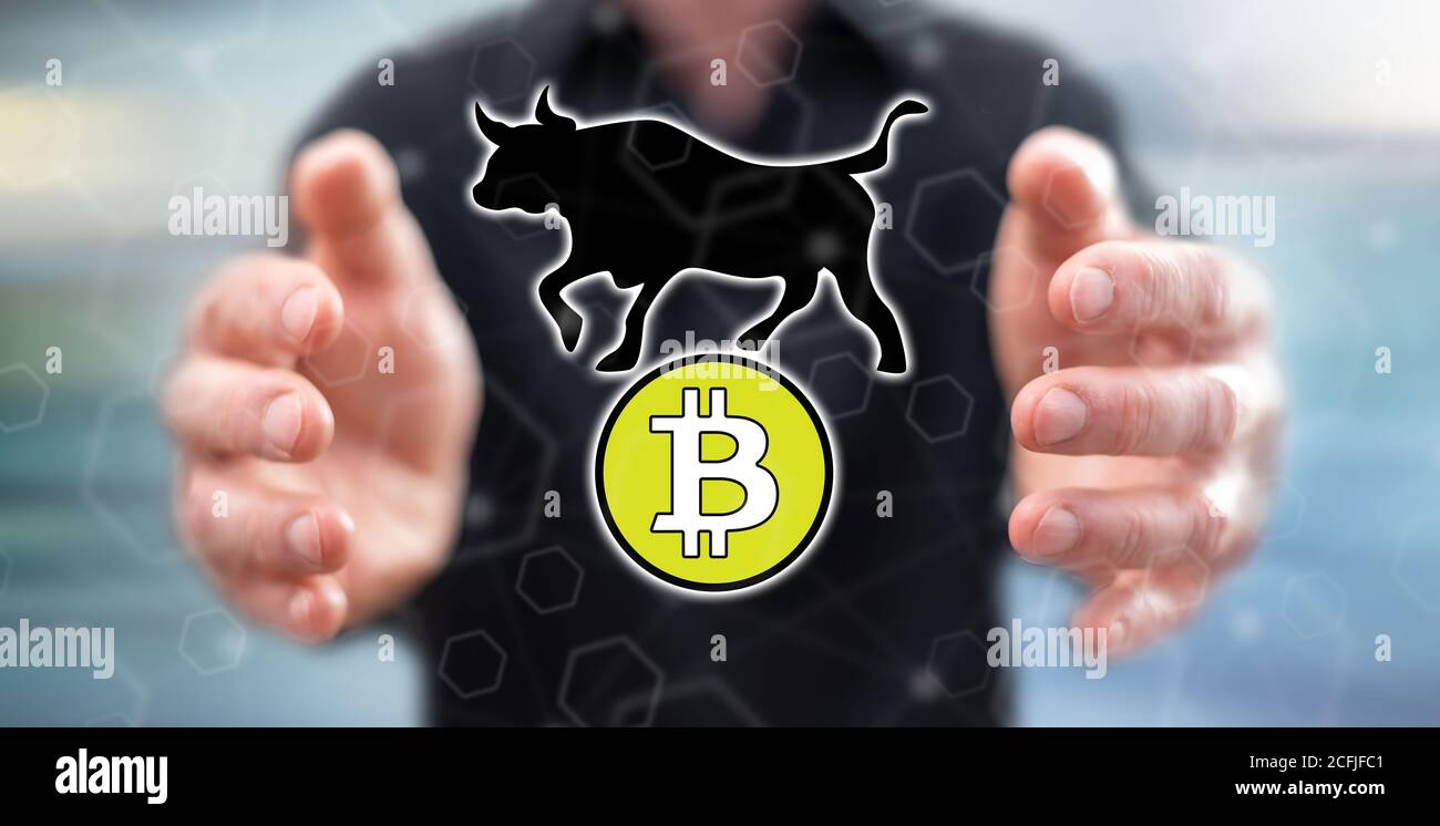 Bitcoin bullish trend concept between hands of a man in background ...