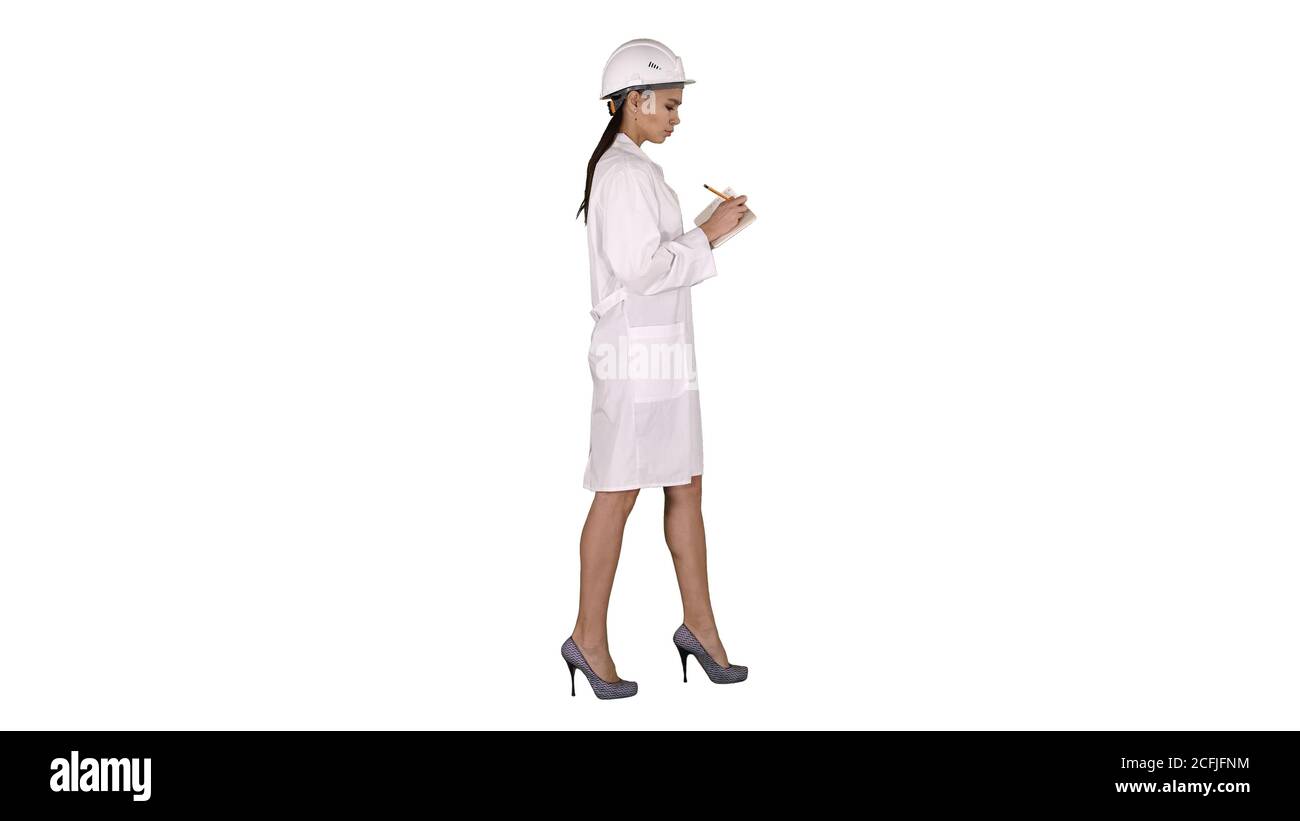 Woman engineer with helmet is holding pen and checklist putting ...